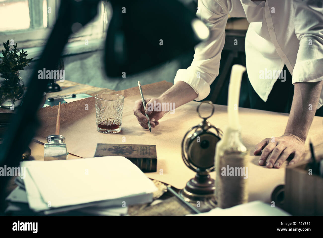 Architect working on drawing table in office Stock Photo - Alamy