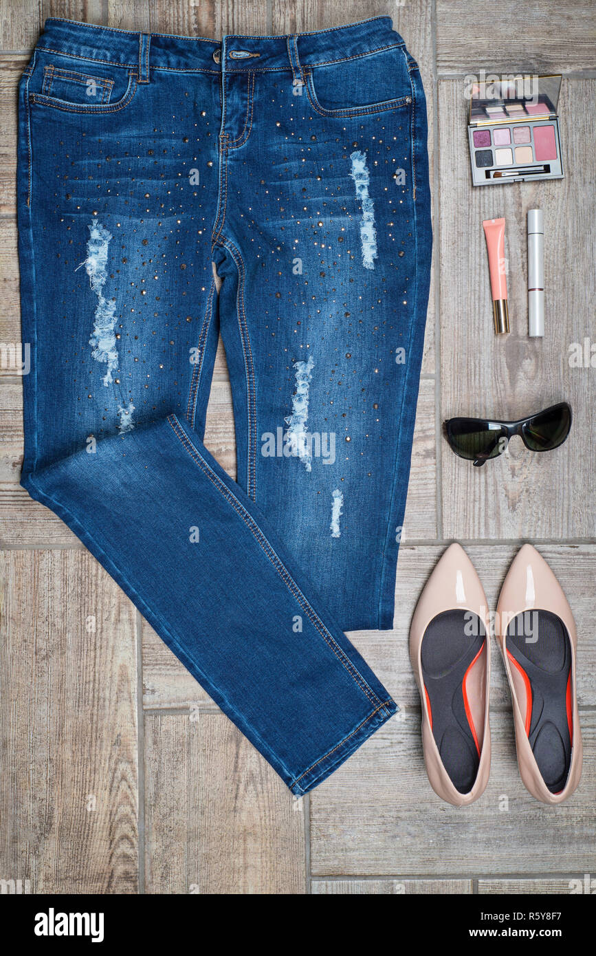 Aerial view of woman's jeans and accessories Stock Photo - Alamy