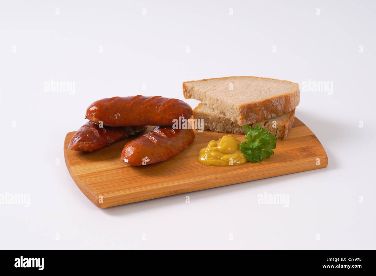 short thick sausages with bread Stock Photo - Alamy