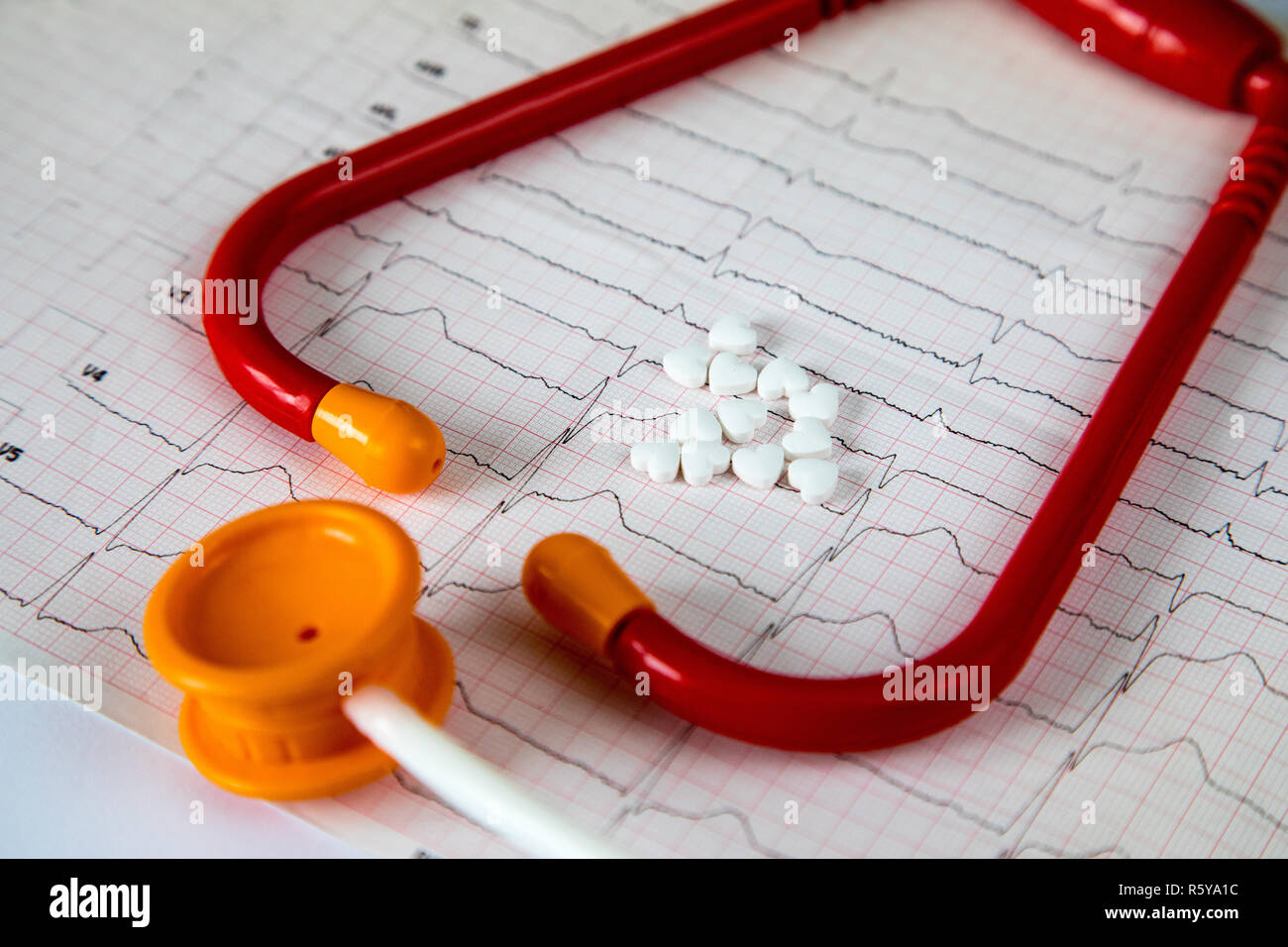 Cardiology. Macro of ECG graph and cardio pills. Pills as a heart Stock ...
