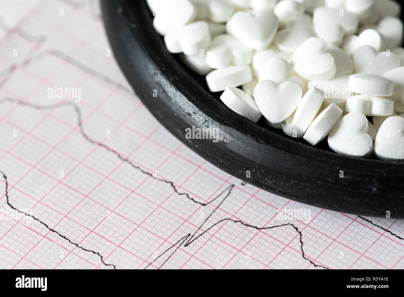 Cardiology. Macro of ECG graph and cardio pills. Pills as a heart Stock ...