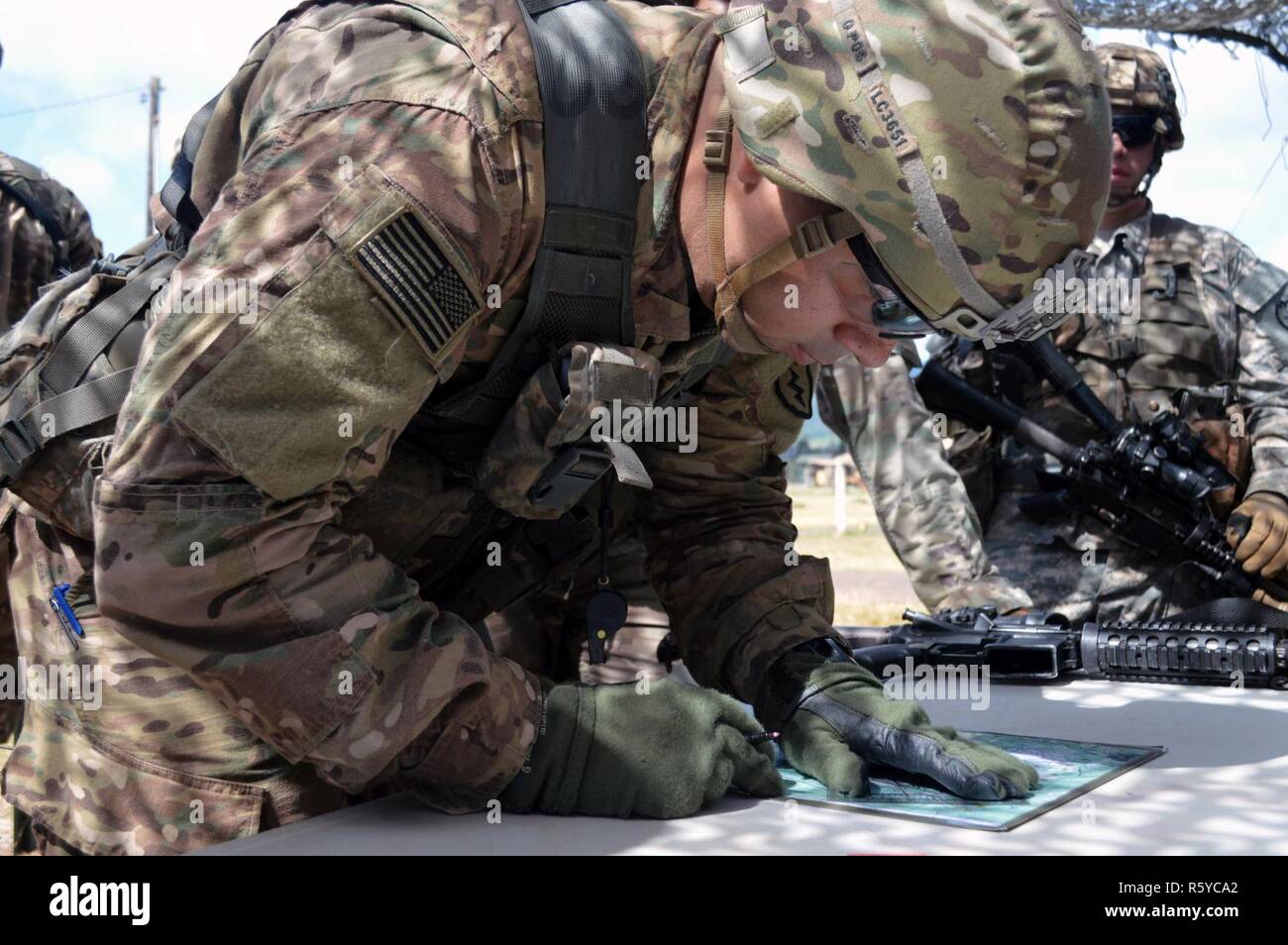 An infantryman assigned to the 25th Infantry Division, determines grid ...