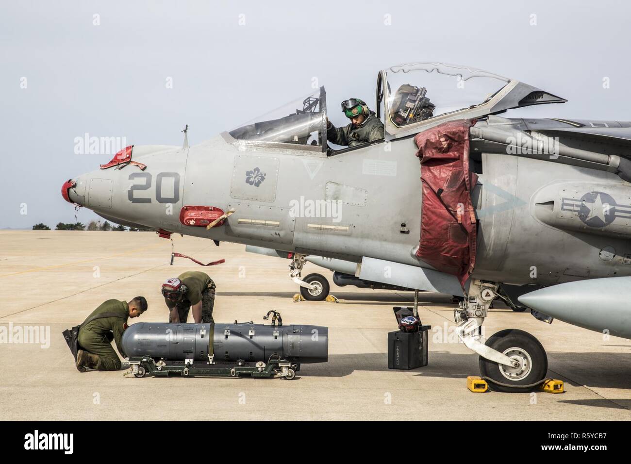 U.S. Marines with Marine Attack Squadron (VMA) 311 work on an AV-8B ...