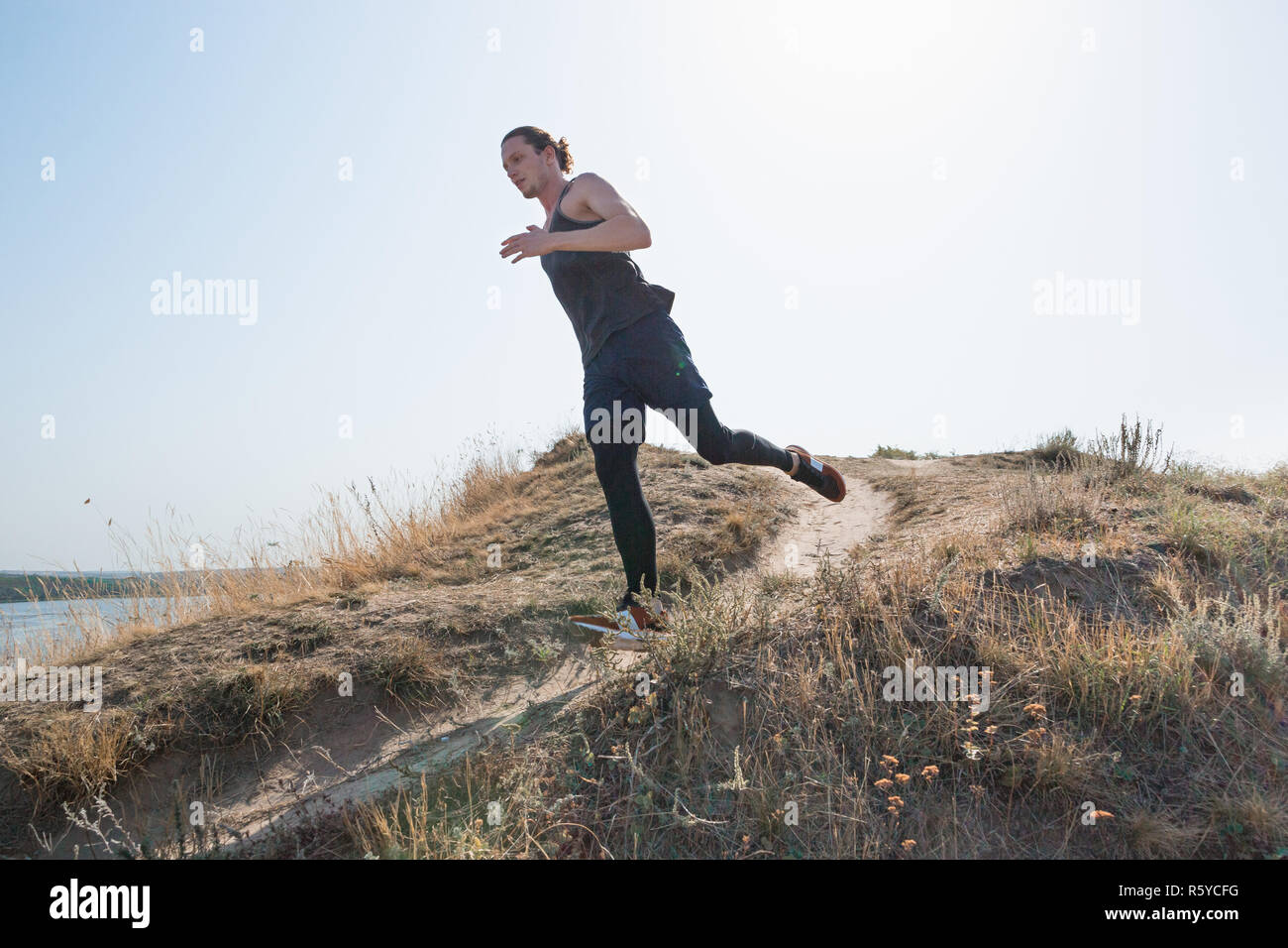 Running sport. Man runner sprinting outdoor in scenic nature. Fit ...