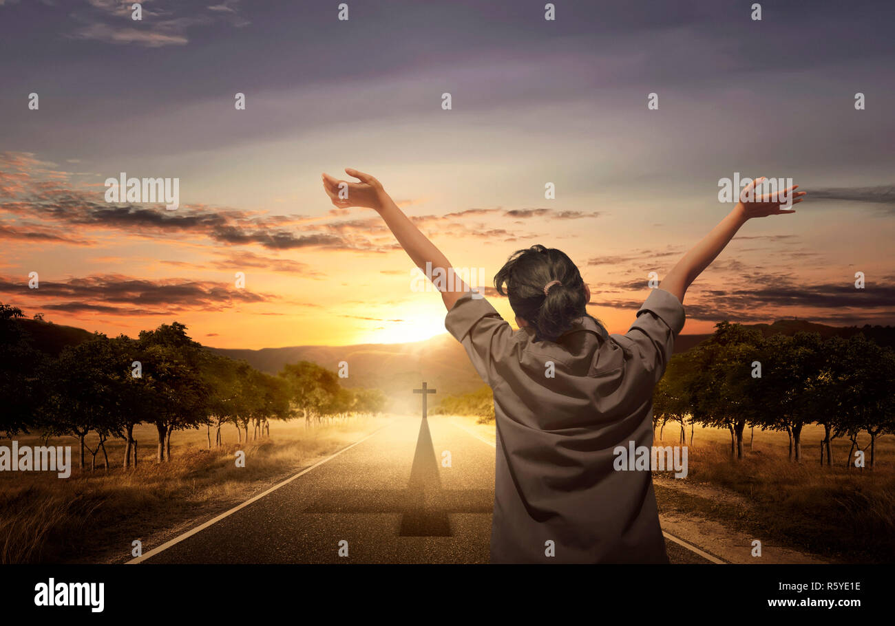 Back view of woman raising hand with open palm while praying Stock ...