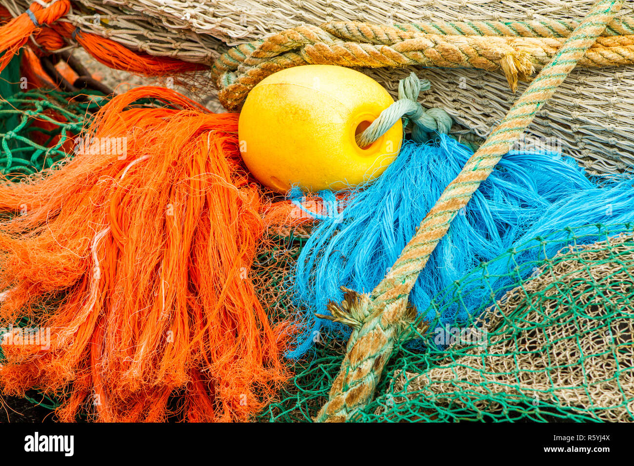 colored fishing nets with ropes and net swimmers Stock Photo - Alamy