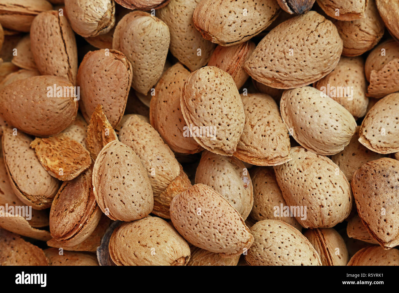 Whole raw almond nuts with shell close up Stock Photo - Alamy