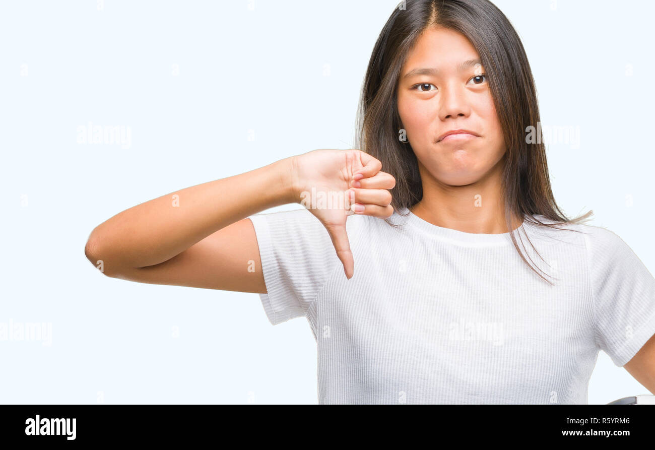 Young asian woman holding football soccer ball over isolated background ...