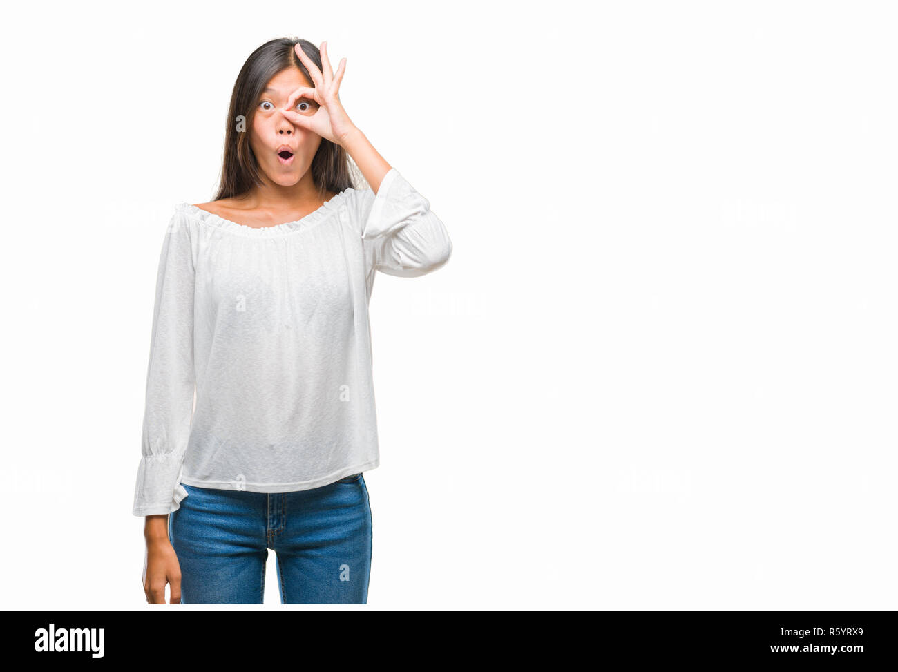 Young asian woman over isolated background doing ok gesture shocked ...