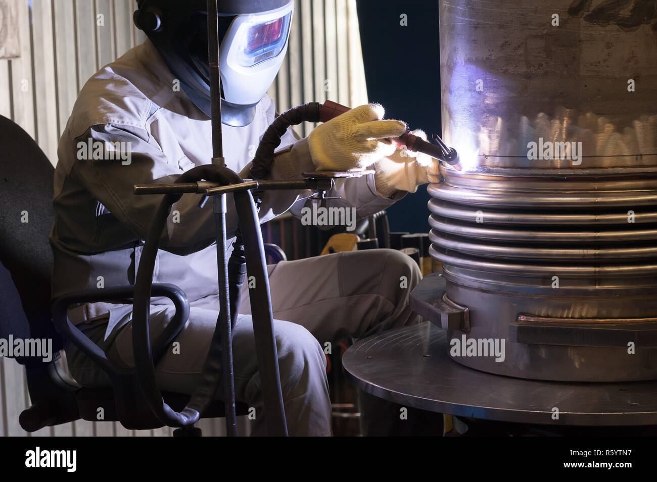 Welder with protective mask welding metal and sparks Stock Photo - Alamy