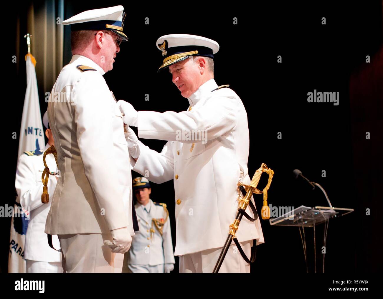 Rear Adm. Dave Callahan, commander of 8th Coast Guard District, pins a ...