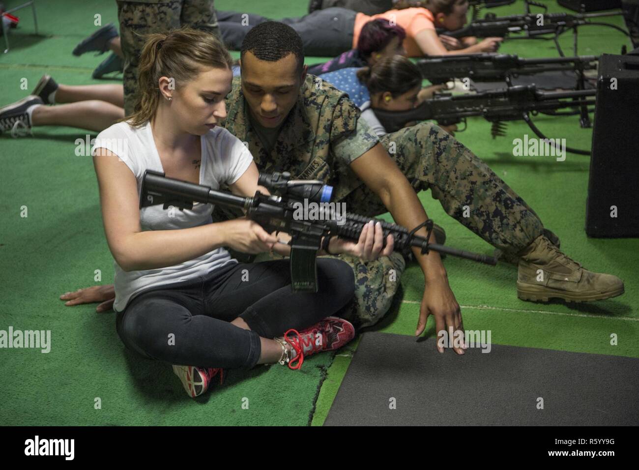 A U.S. Marine with II Marine Expeditionary Force (II MEF) assists his ...