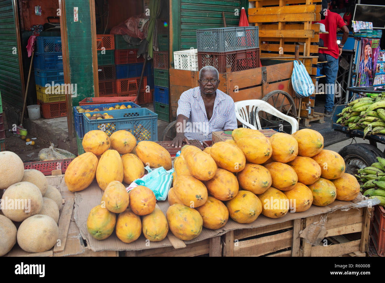 Afro-Colombian man selling papaya at the local Bazurto market ...