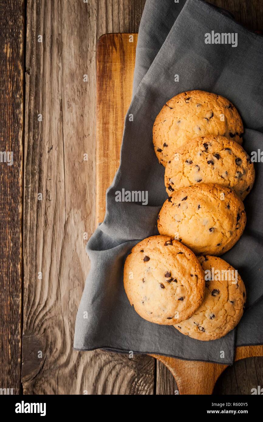 Chocolate chip cookies with milk on the wooden table vertical Stock ...