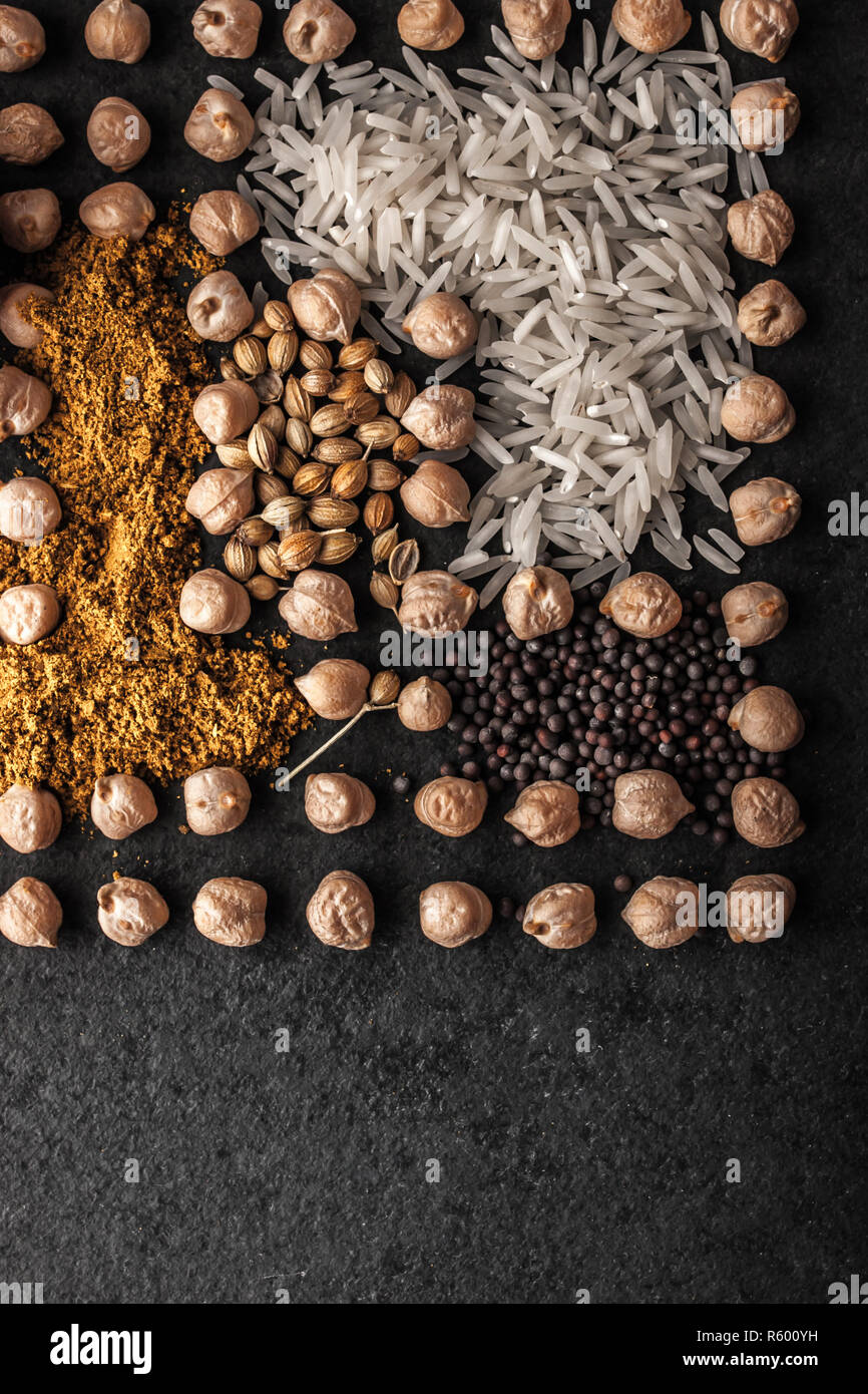 Composition of chick-peas , rice and spice on the dark stone vertical ...