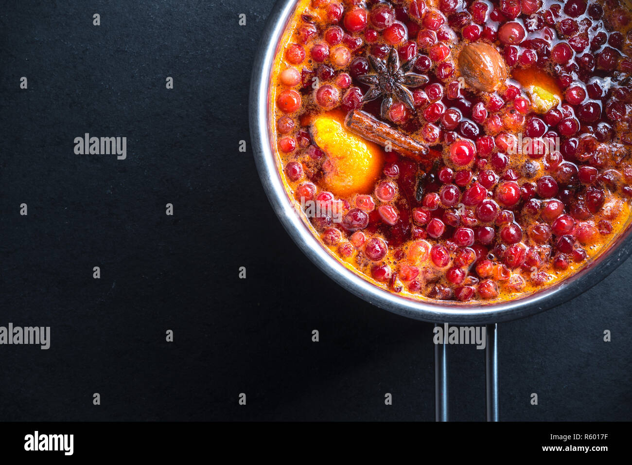Preparation of sauce from cranberry, peel and nutmeg Stock Photo - Alamy