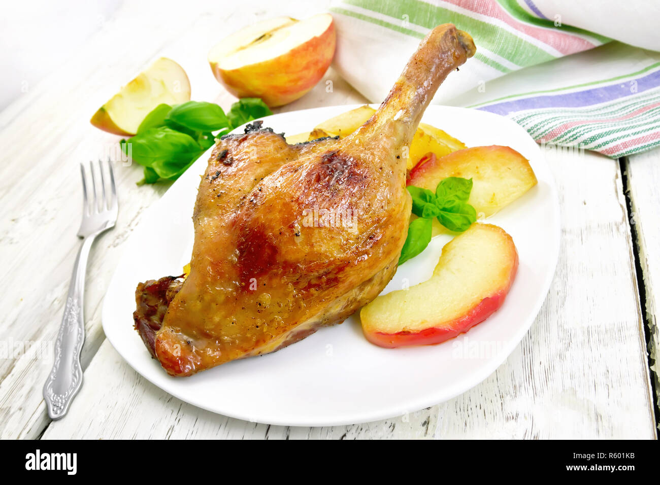 Duck leg with apple on board Stock Photo - Alamy