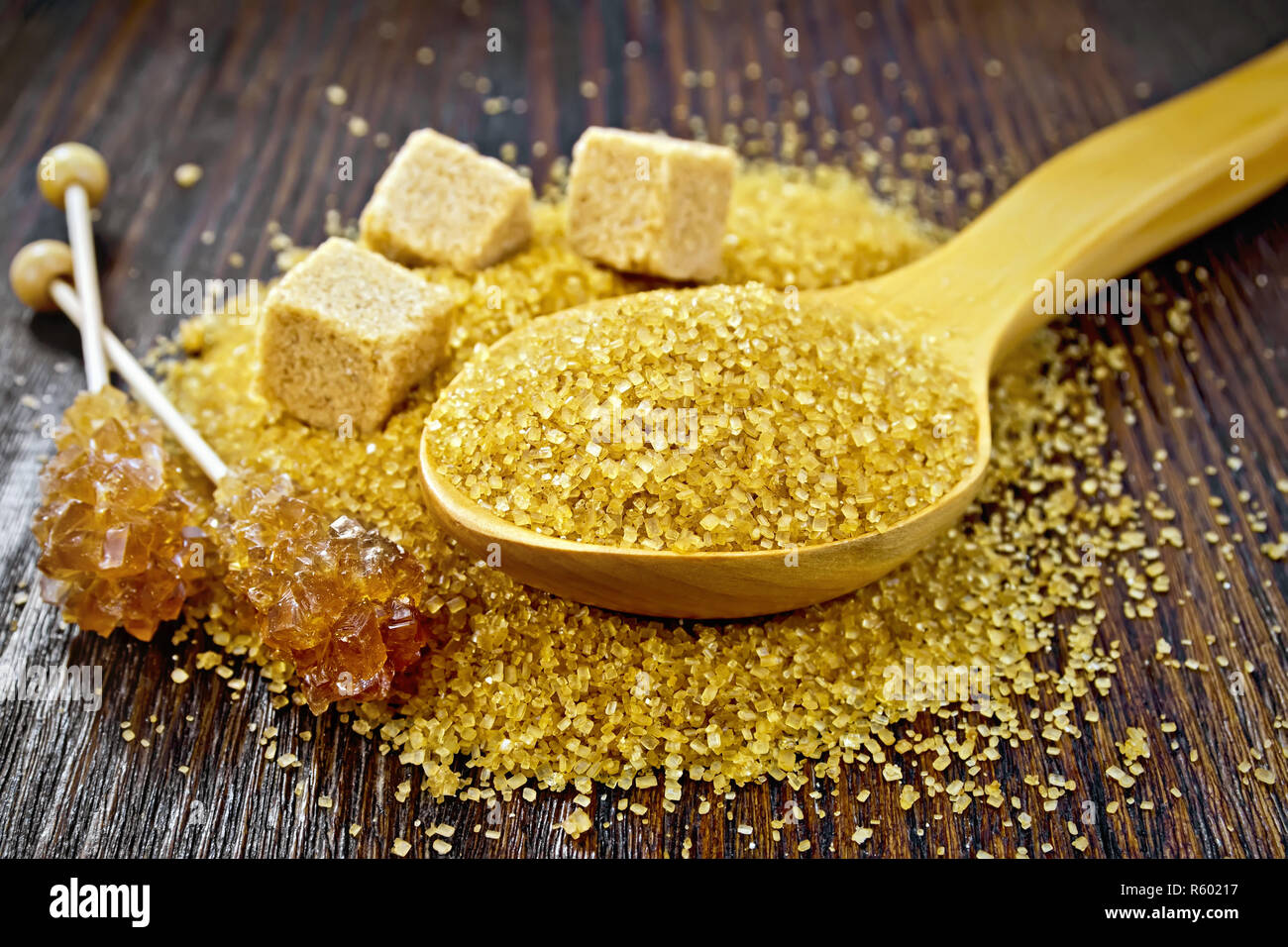 Sugar brown in spoon on board Stock Photo - Alamy