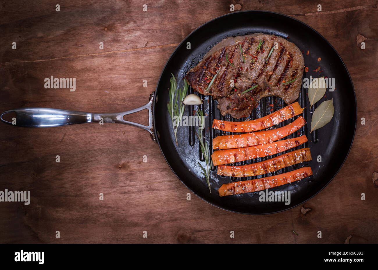 fried piece of beef on a round frying pan Stock Photo - Alamy