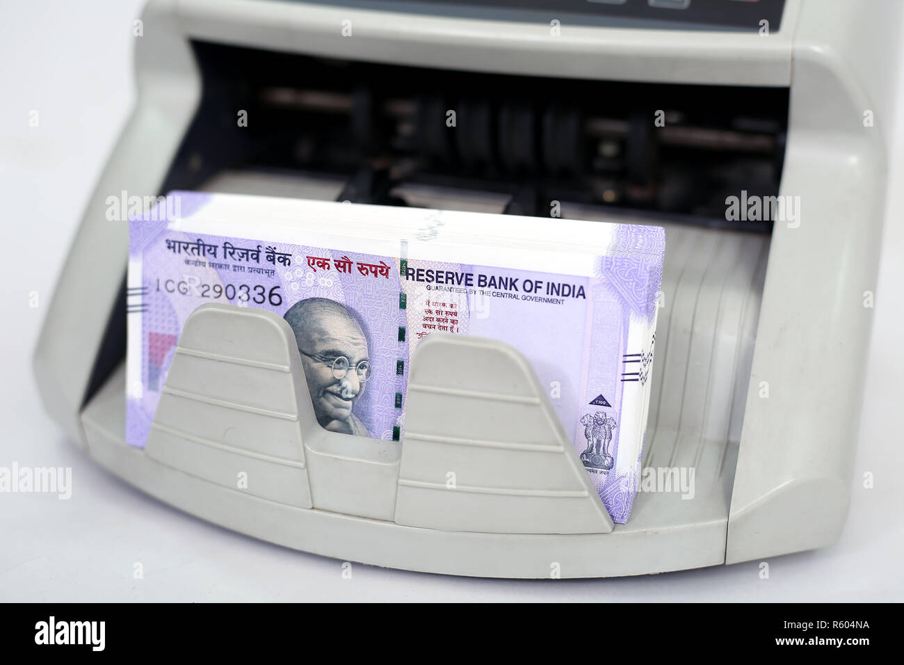 Electronic currency counter machine with new Indian currency. Isolated ...