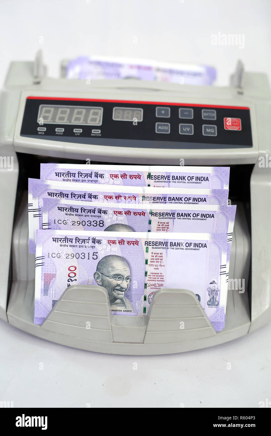 New Indian currency notes in the cash counting machine. Isolated on the ...