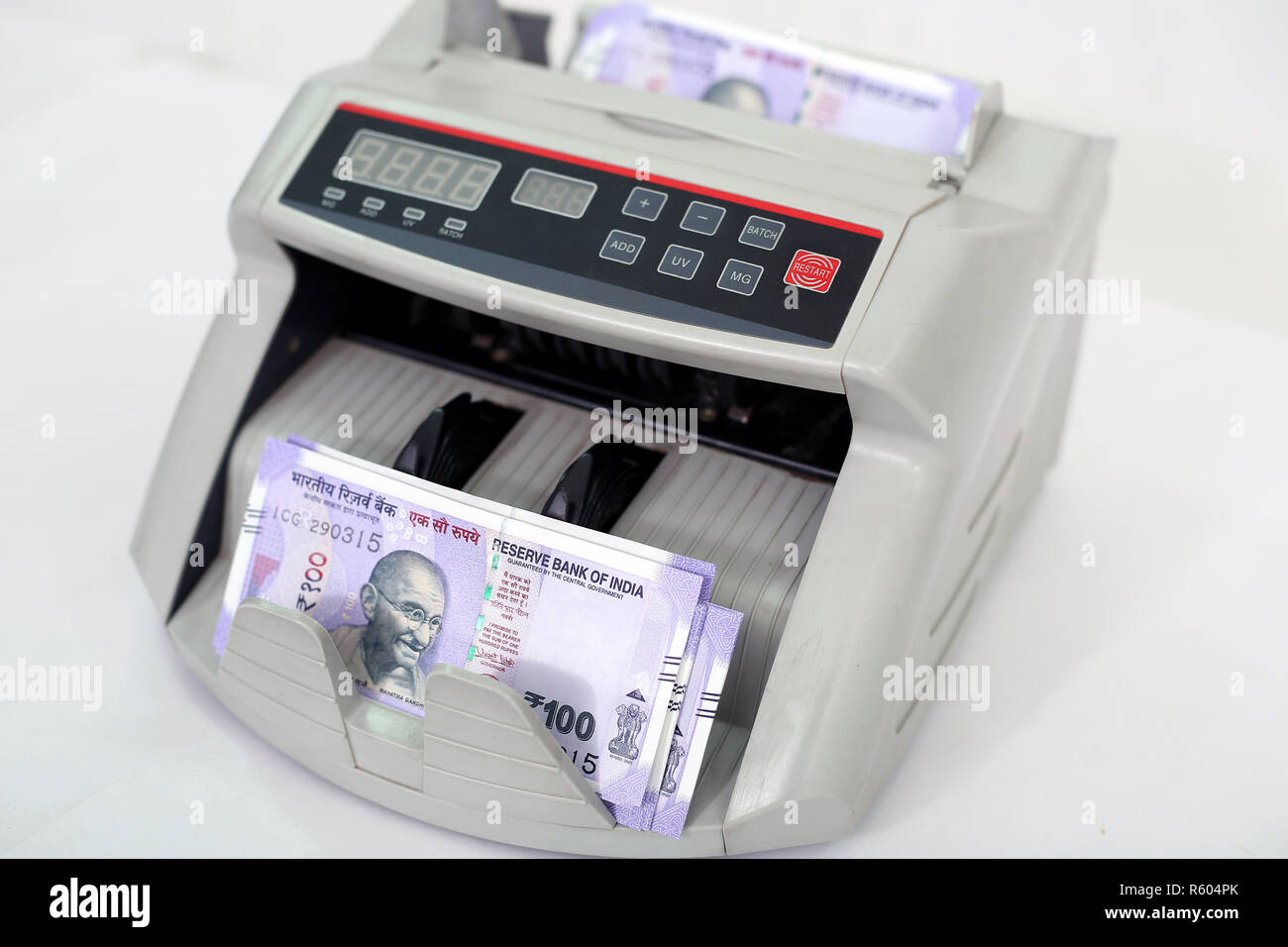 Counting currency in the money counting machine. Isolated on the white ...