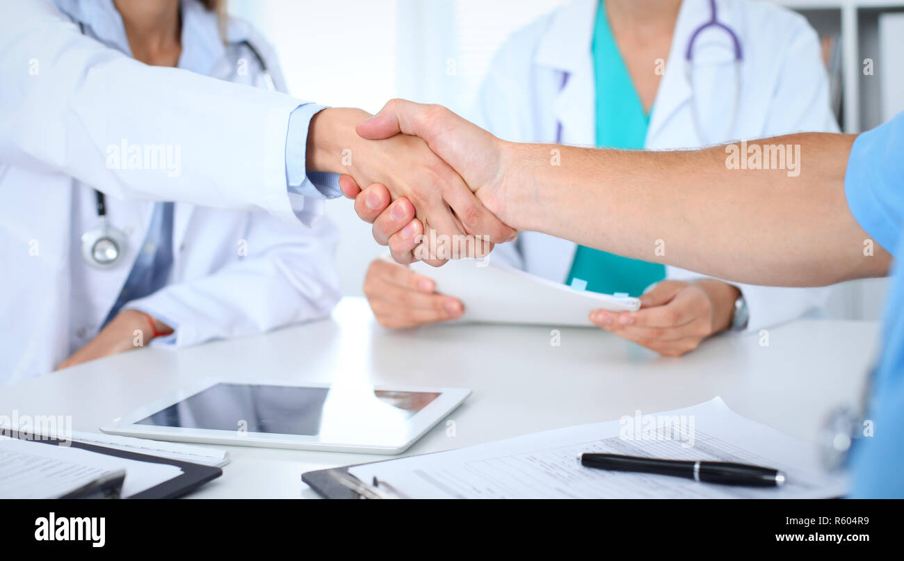 Group doctors joining hands hi-res stock photography and images - Alamy