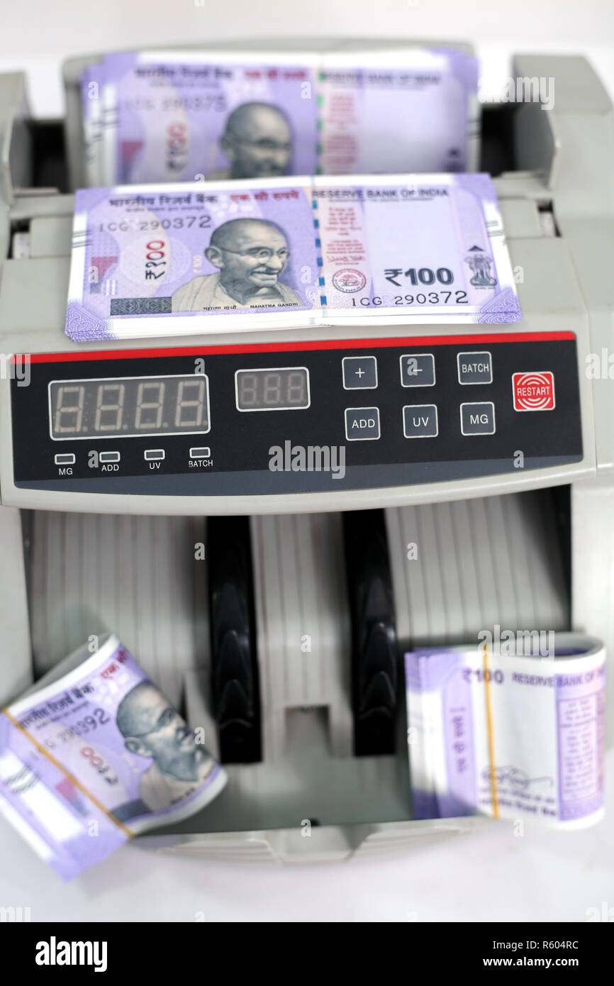 Electronic money counter with new 100 rupees notes. Isolated on the ...