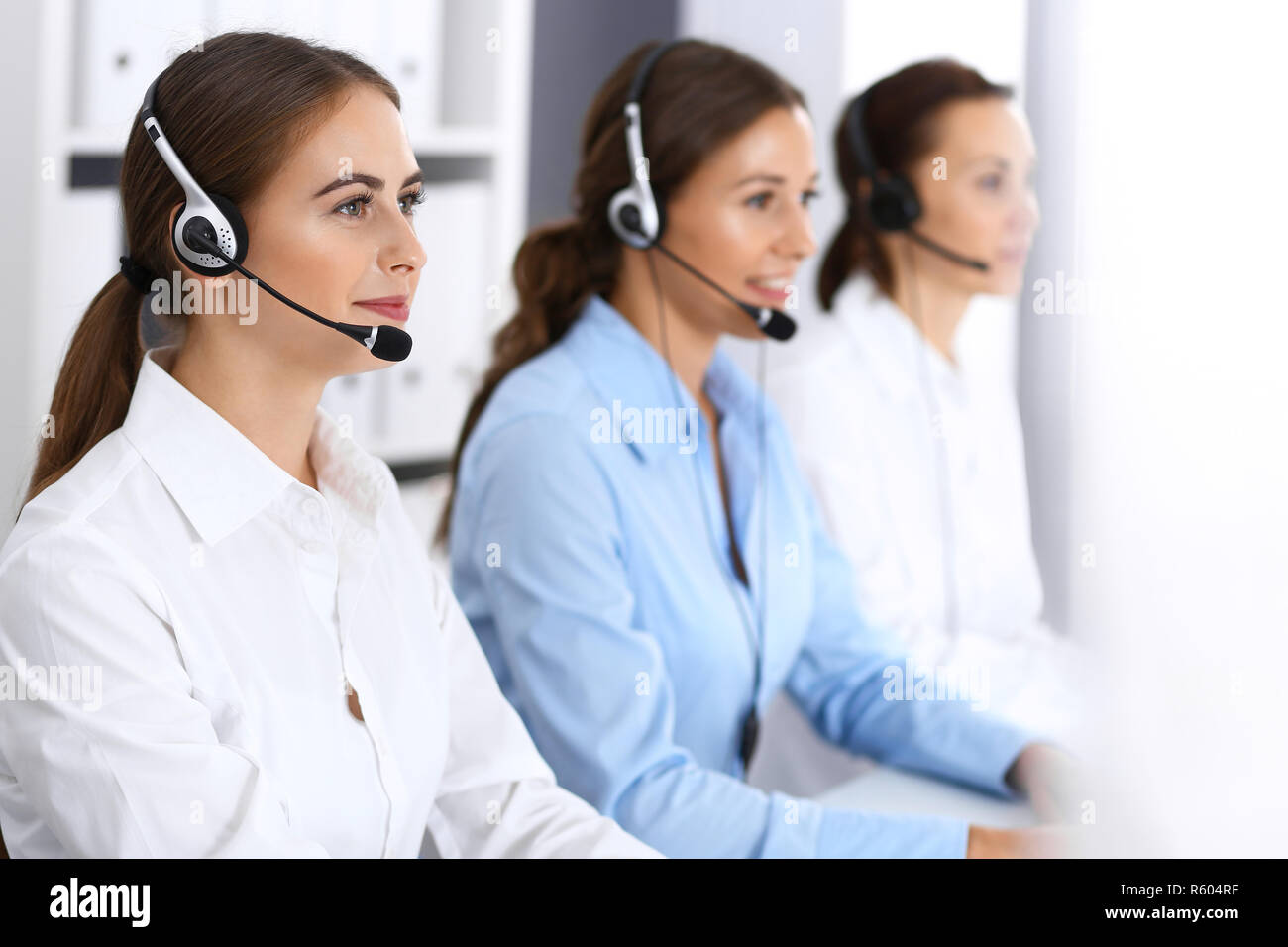 Call center. Group of operators at work. Focus at beautiful business ...