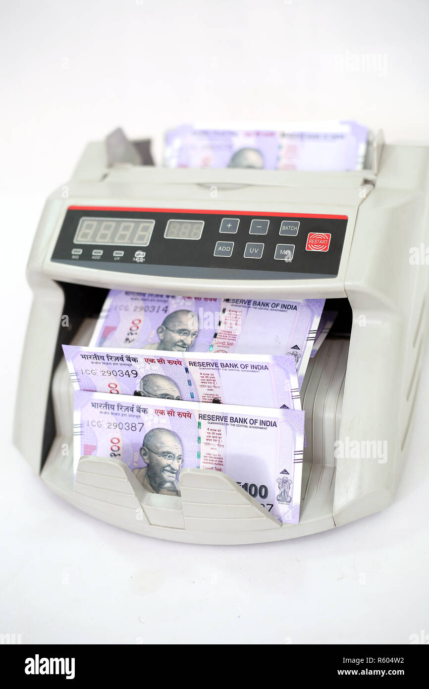 Electronic money counter with new Indian 100 rupees notes. Isolated on ...