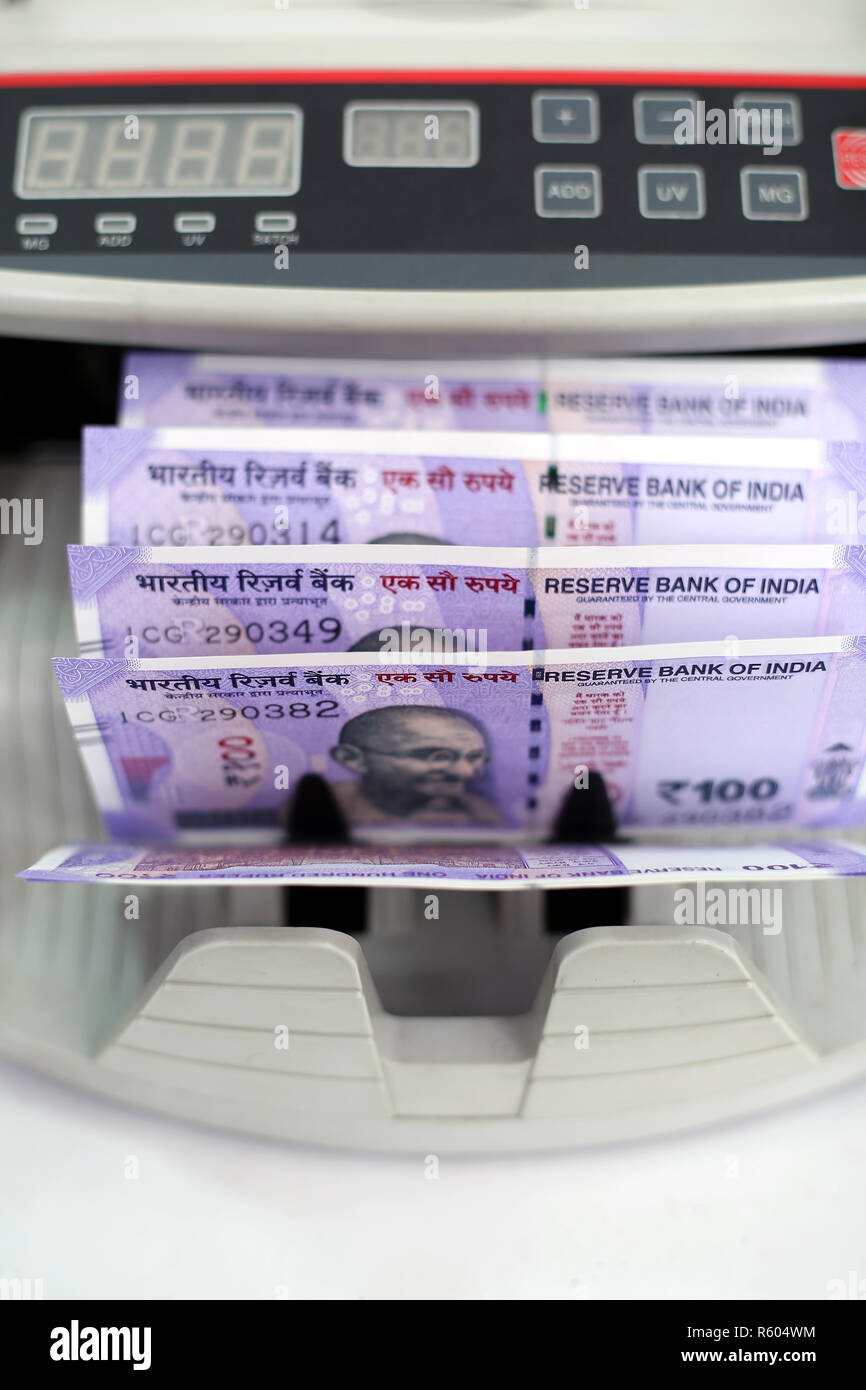 Banknote counter and new Indian banknotes. Isolated on the white ...