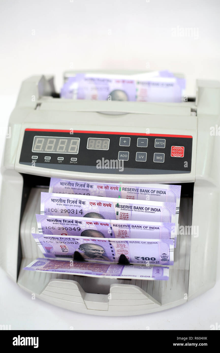 Counting of new Indian currency on automatic machine. Isolated on the ...