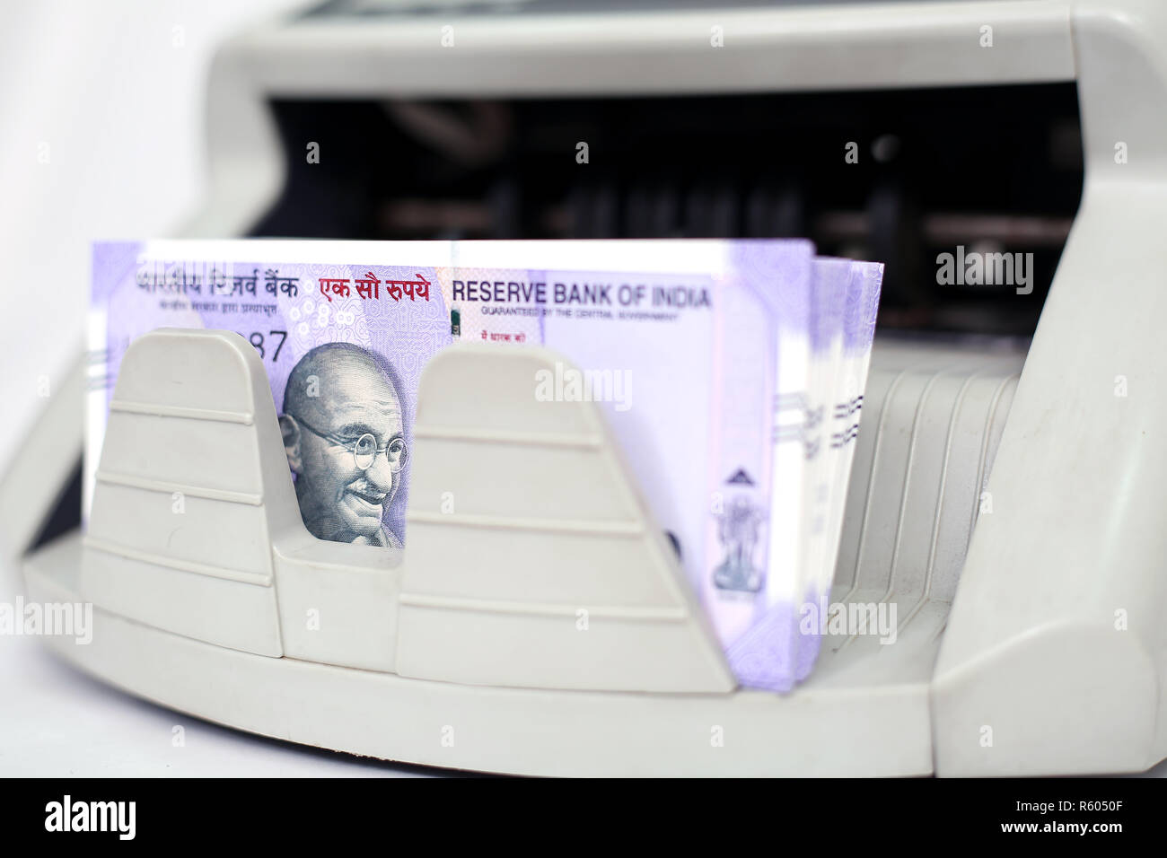 New Indian currency in cash deposit machine. Isolated on the white ...