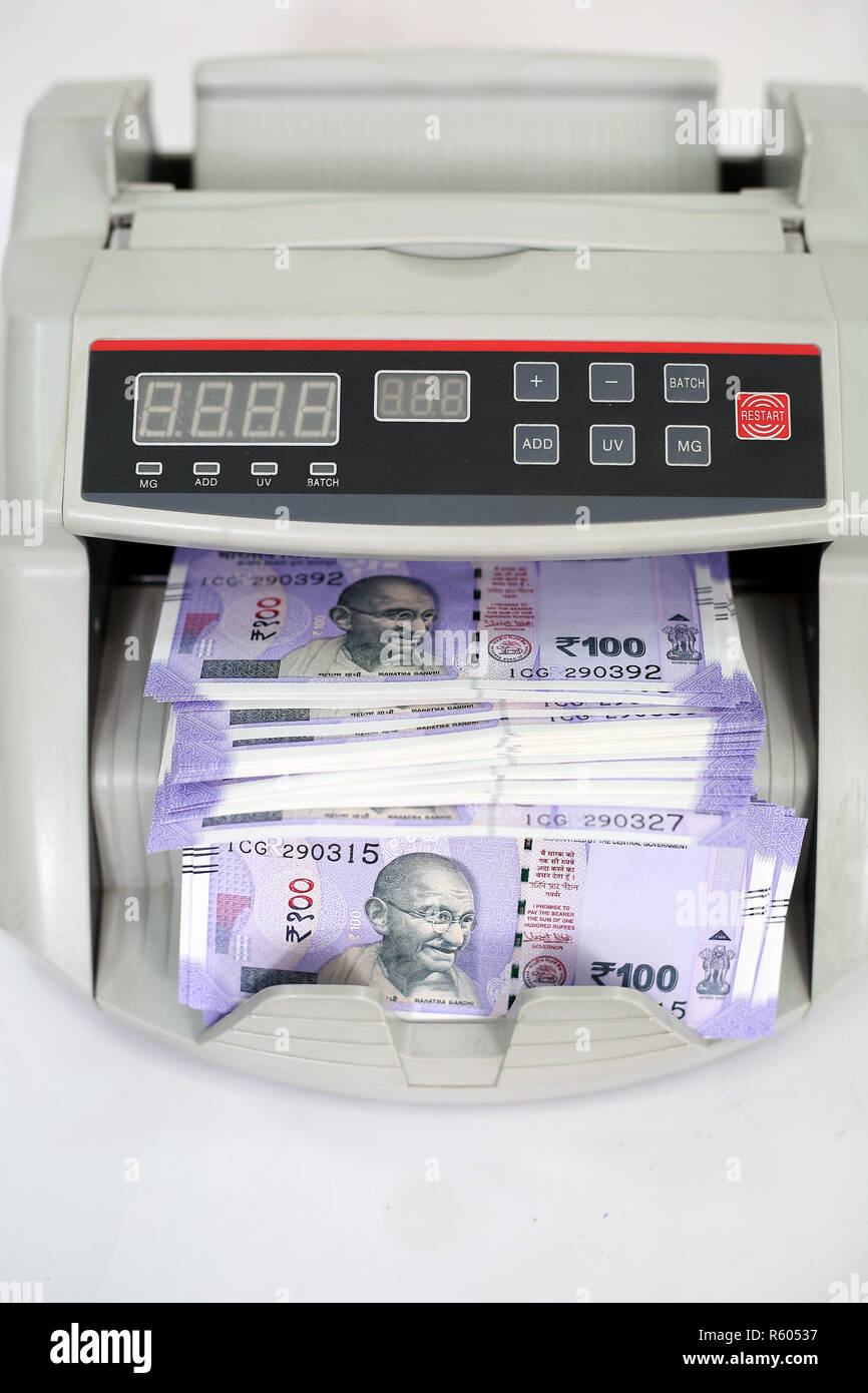 New Indian banknotes at the currency counter machine. Isolated on the ...