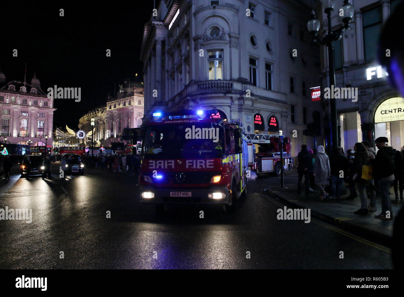Fire Engine emegency vehicle moving through streets with light flashing ...