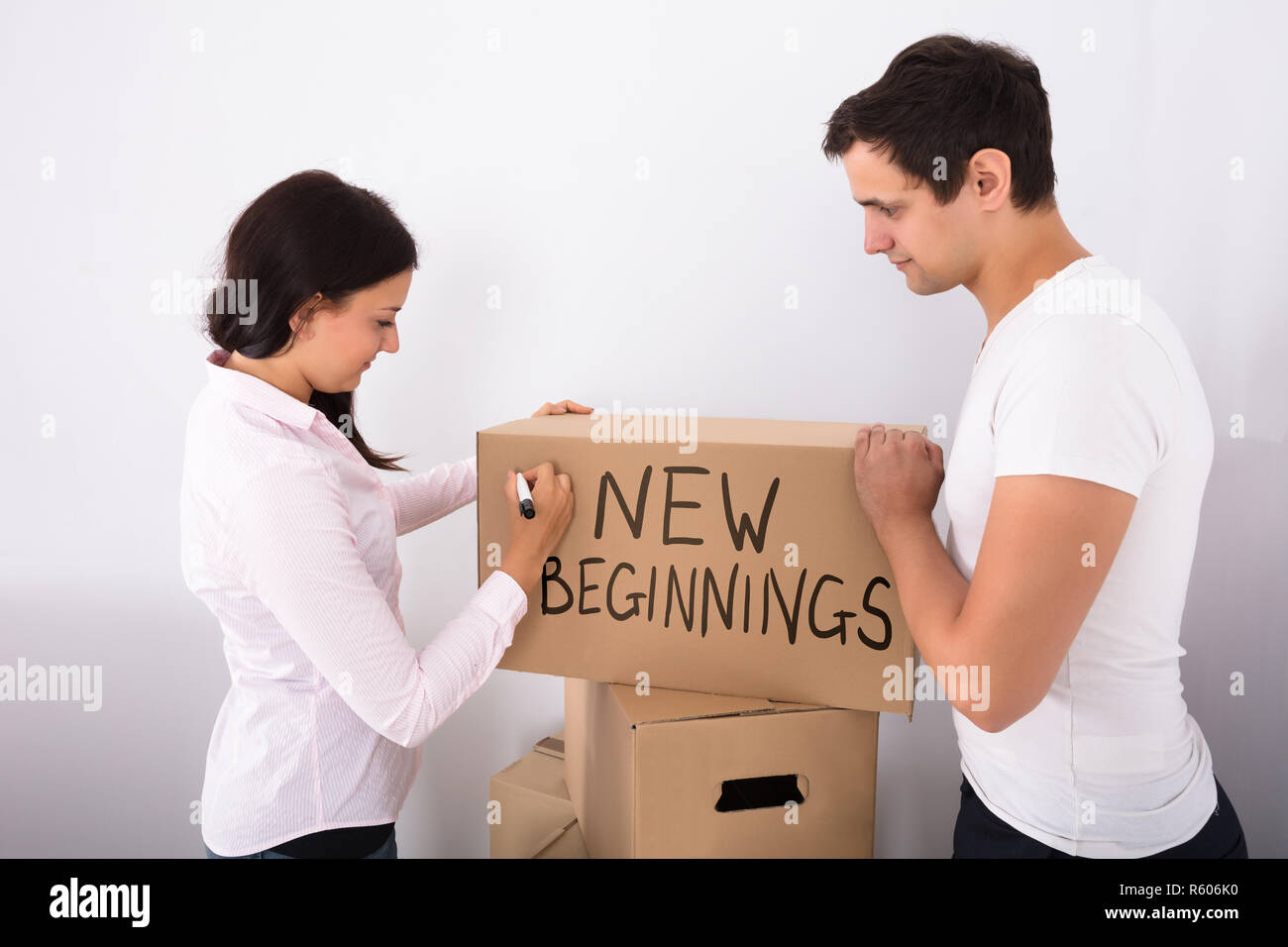 Woman Writing On Cardboard Box New Beginnings Stock Photo - Alamy