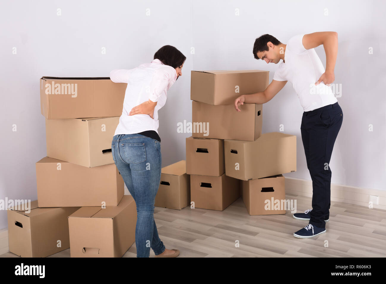 Couple Have Backpain While Moving The Boxes Stock Photo - Alamy