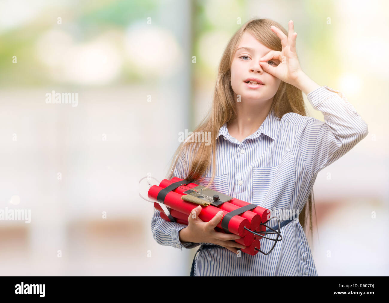 Young blonde child holding dynamite bomb with happy face smiling doing ...