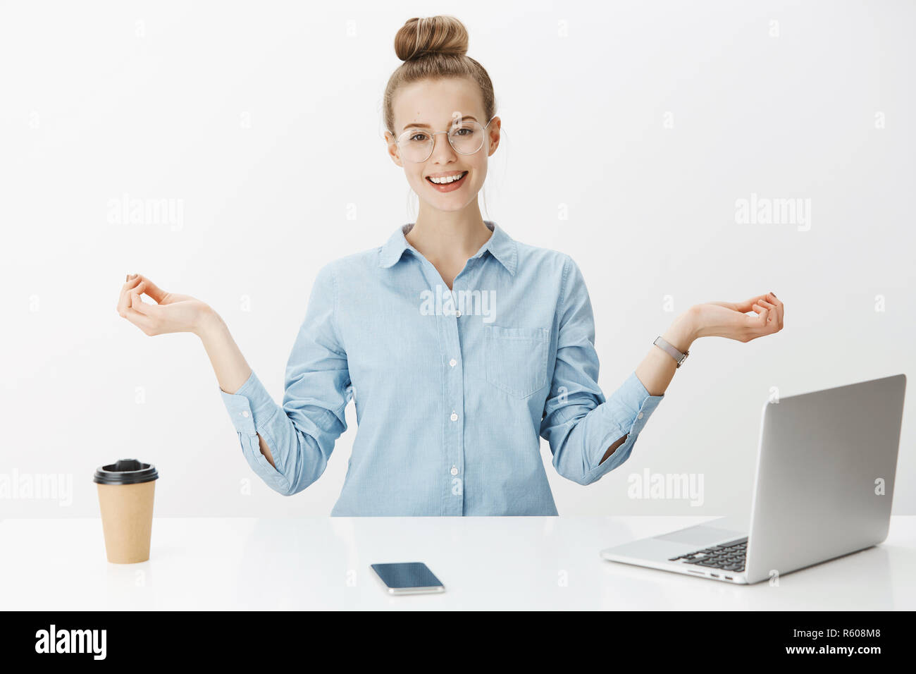 Energized and happy young creative female office worker staying ...