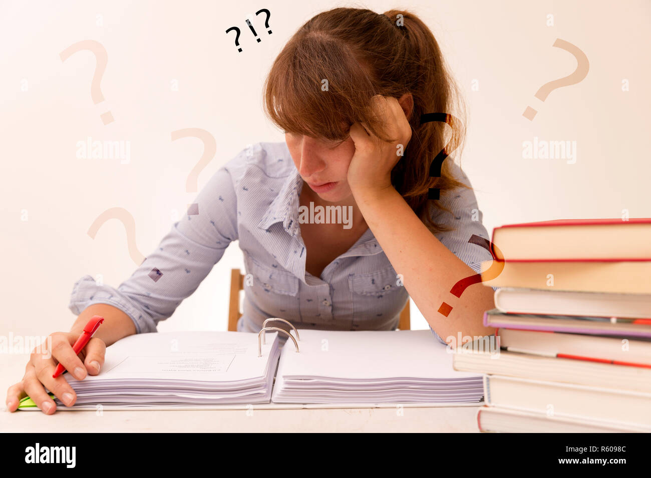 Young woman studying and reading in a library but is having a hard time ...