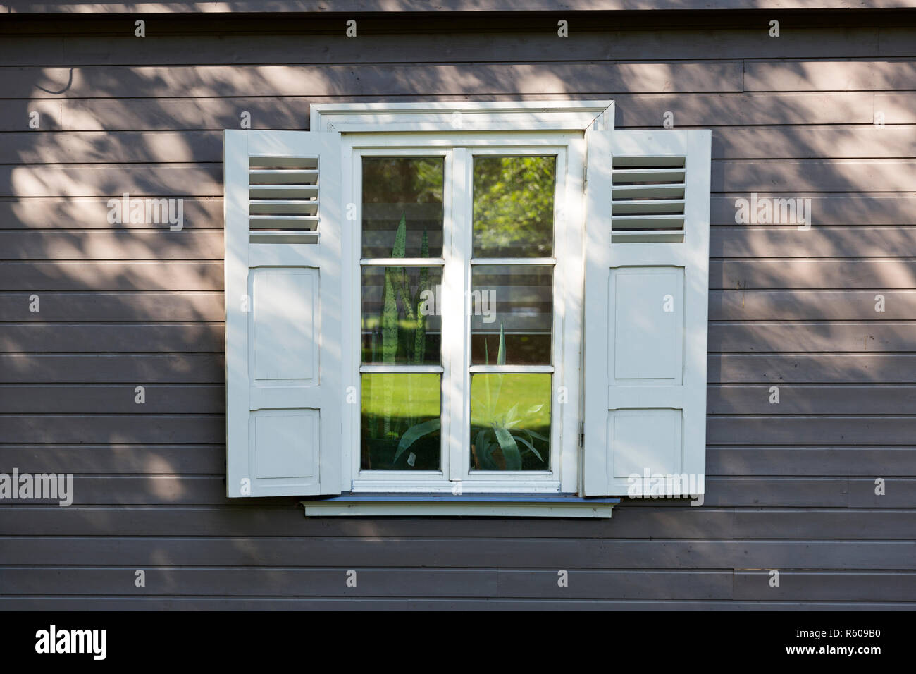 small vintage white window with shutters on wooden grey wall Stock ...