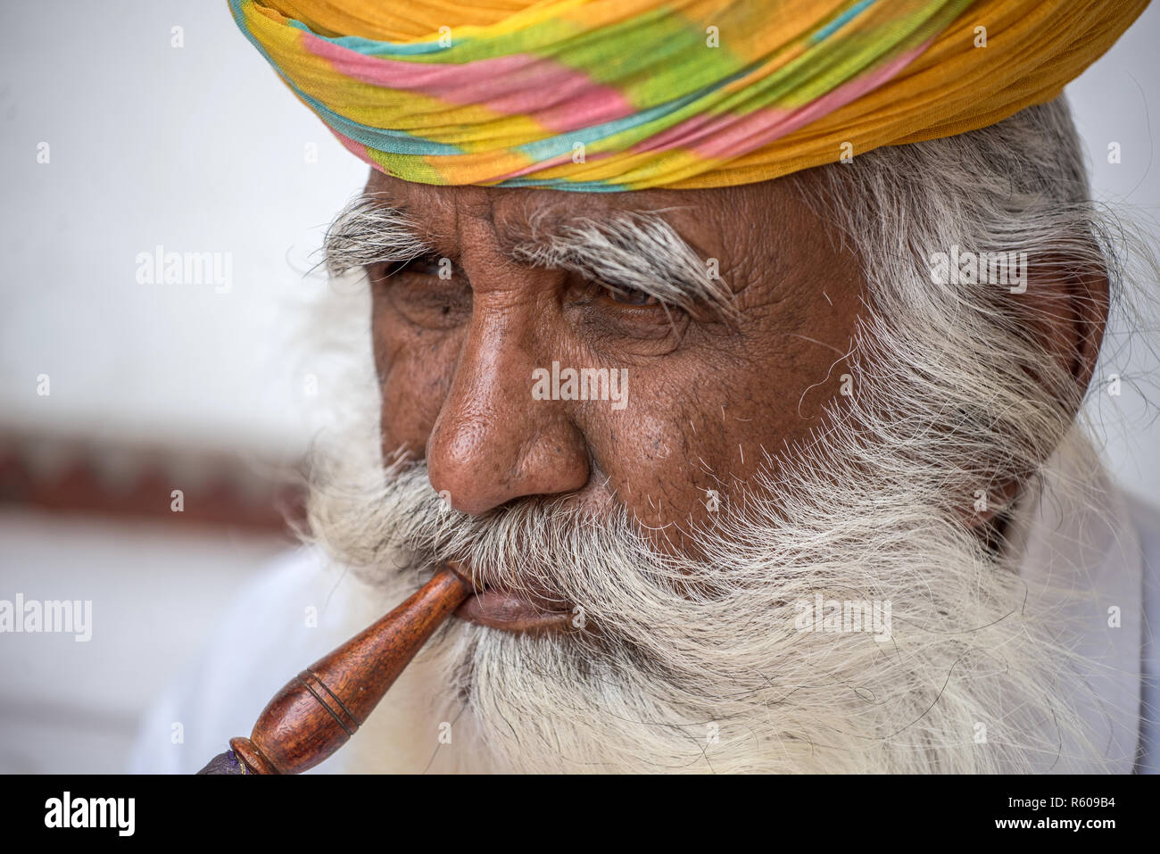 Indian man with yellowish turban smoking the hookah, Mehrangarh Fort ...