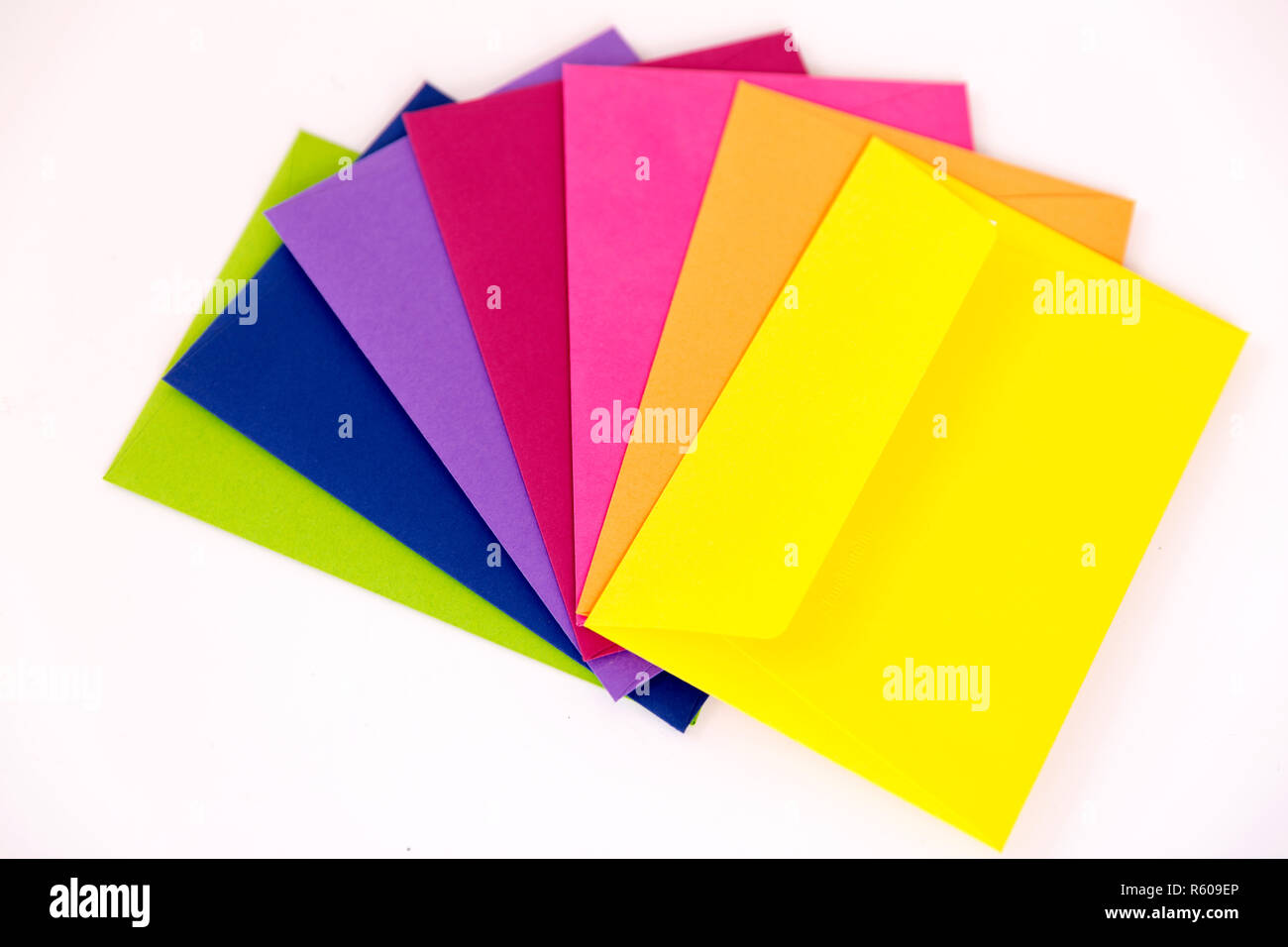 Different colored envelopes on the table Stock Photo - Alamy