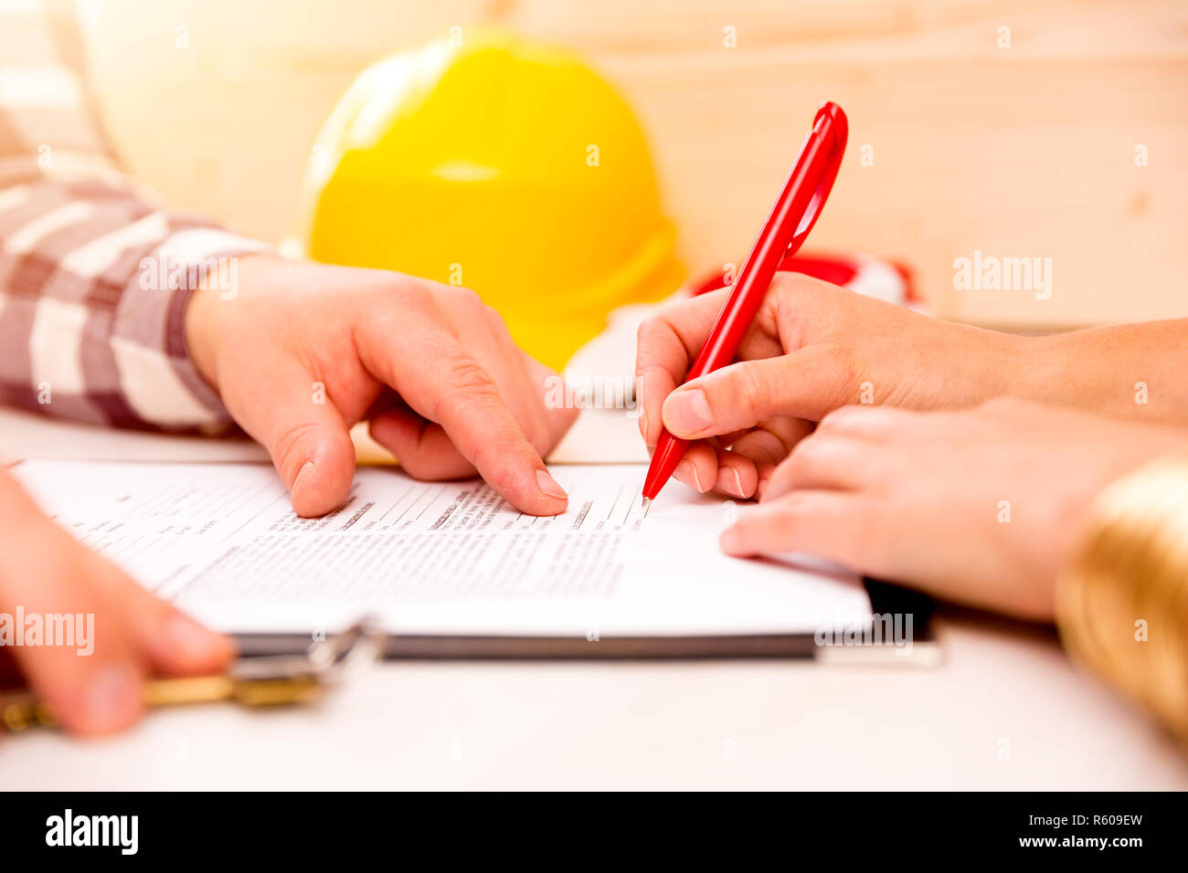 Woman signing construction contract with contractor to build a house ...