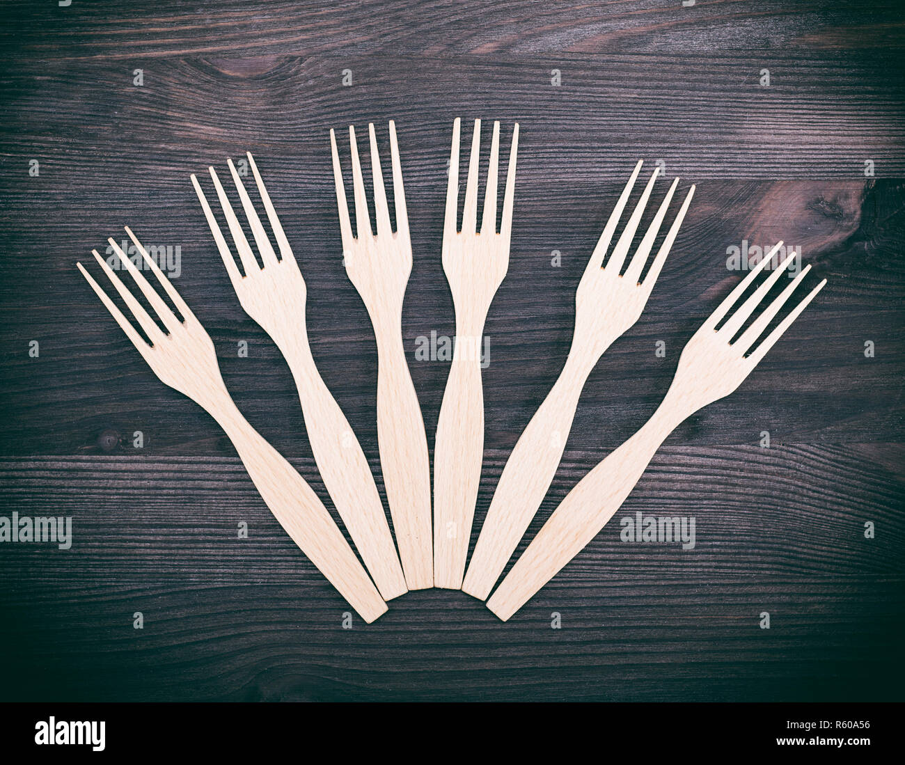 carved wooden forks on a brown background Stock Photo - Alamy