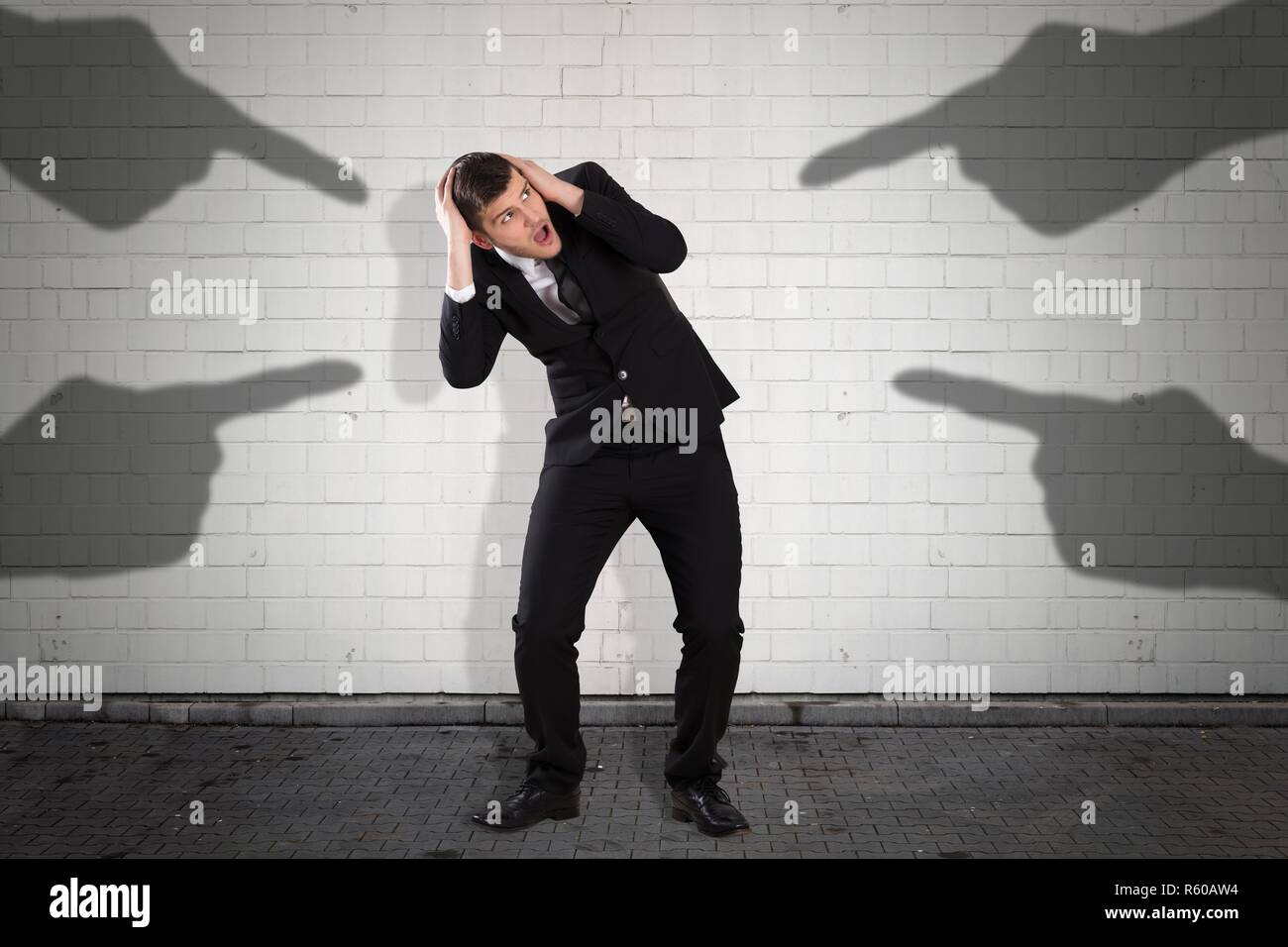 Shadow Hands Pointing Towards Businessman Stock Photo - Alamy