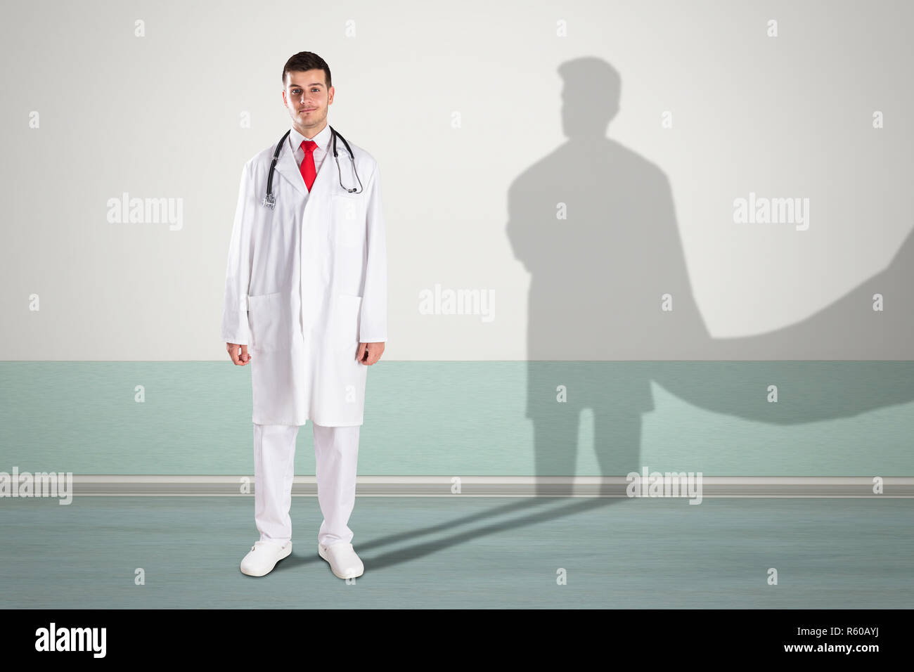 Doctor With Superhero Shadow On Wall Stock Photo - Alamy