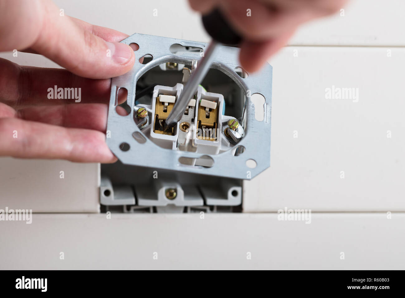 Person's Hand Repairing Electrical Socket Stock Photo - Alamy