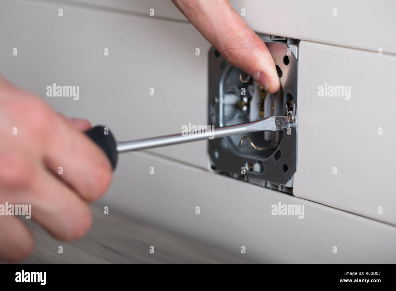 Person's Hand Repairing Electrical Socket Stock Photo - Alamy