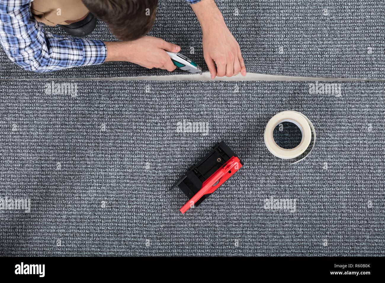 Carpenter Laying Carpet Stock Photo - Alamy